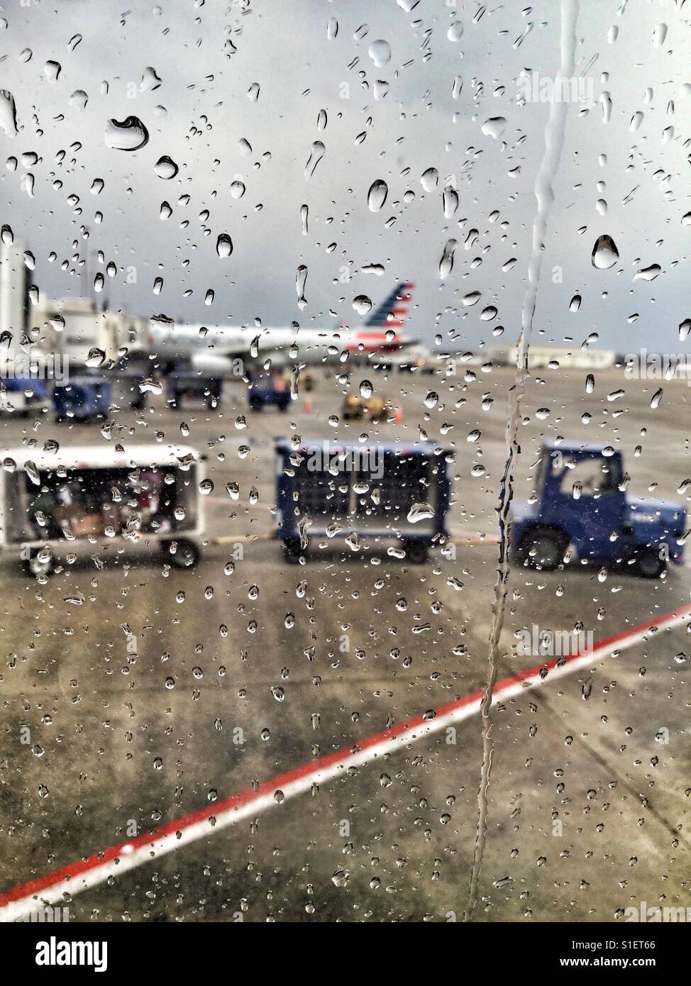 Looking out a plane window on a rainy day Stock Photo - Alamy
