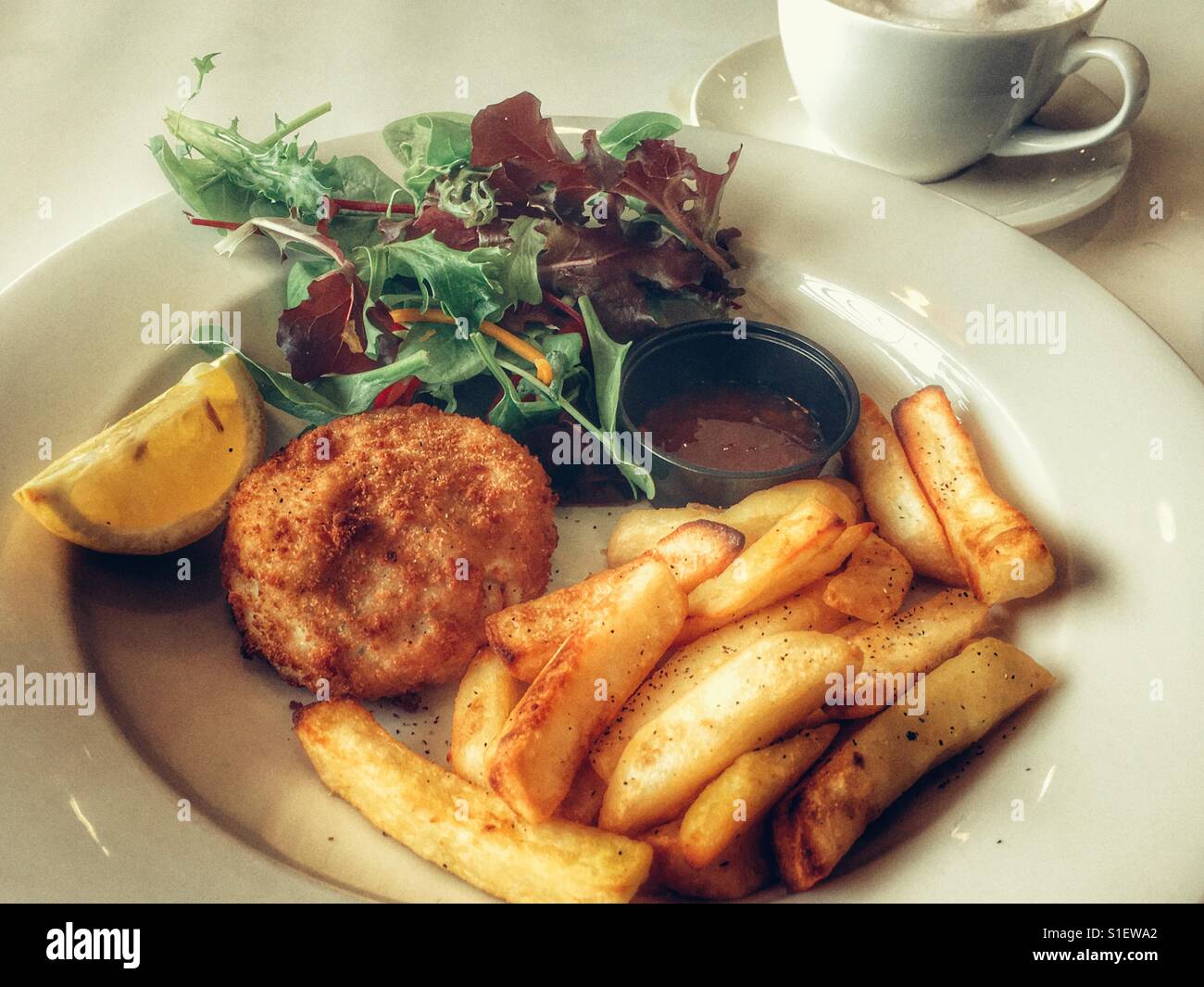 Waitrose fish cake with sweet chilli sauce, chips and free coffee Stock ...