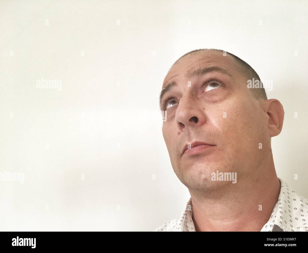 Portrait of a man looking up Stock Photo - Alamy