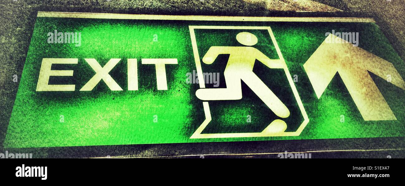 Emergency Exit sign with a running figure and arrow Stock Photo - Alamy