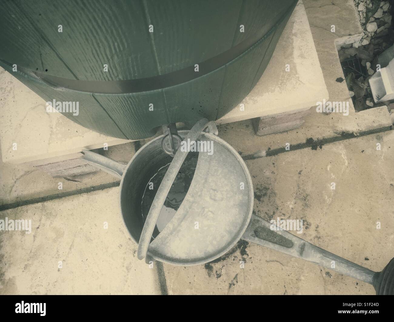 Watering can being filled up with water Stock Photo - Alamy