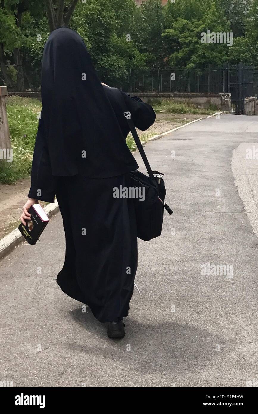 A nun Walking with a book Stock Photo - Alamy