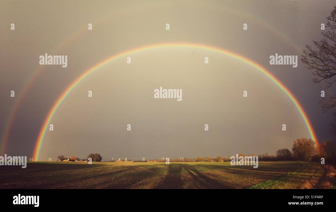 Complete rainbow over fields Stock Photo - Alamy