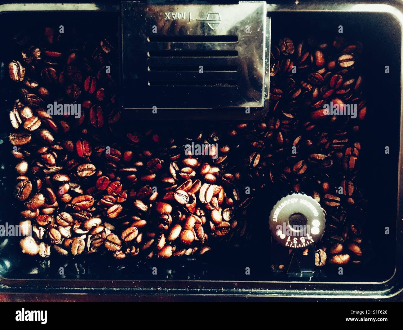 Coffee beans in bean to cup Coffee machine Stock Photo - Alamy