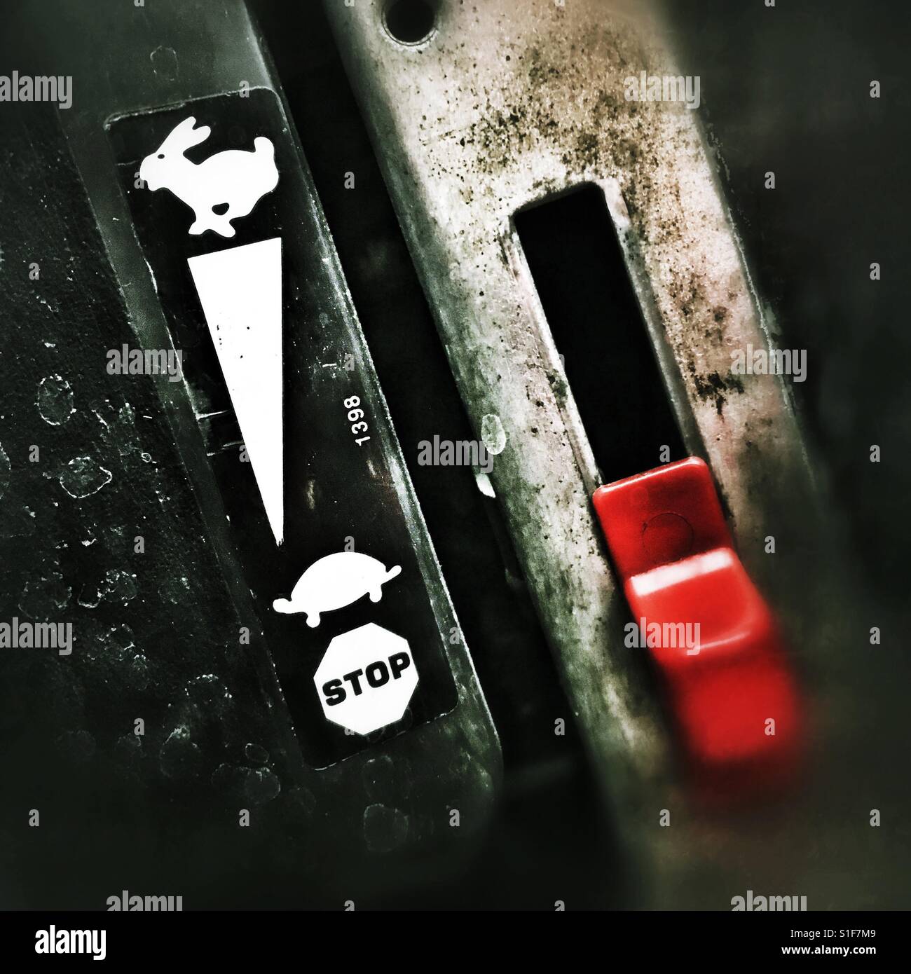 A switch on a machine with a hare and a turtle representing slow and ...