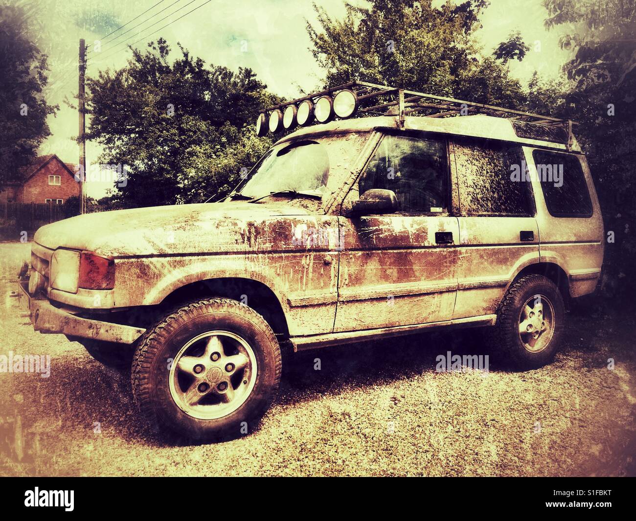 Land Rover Discovery covered in mud Stock Photo - Alamy