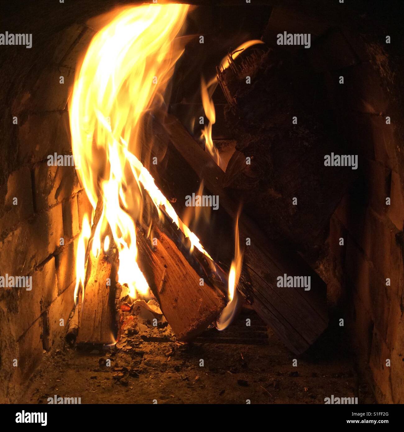 Burning fire in fireplace Stock Photo - Alamy
