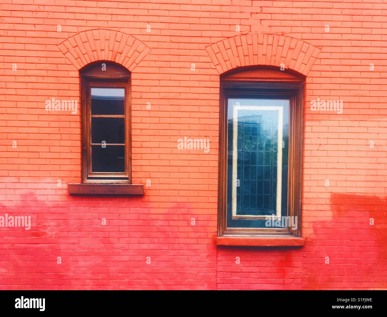 Two windows on brick wall Stock Photo - Alamy