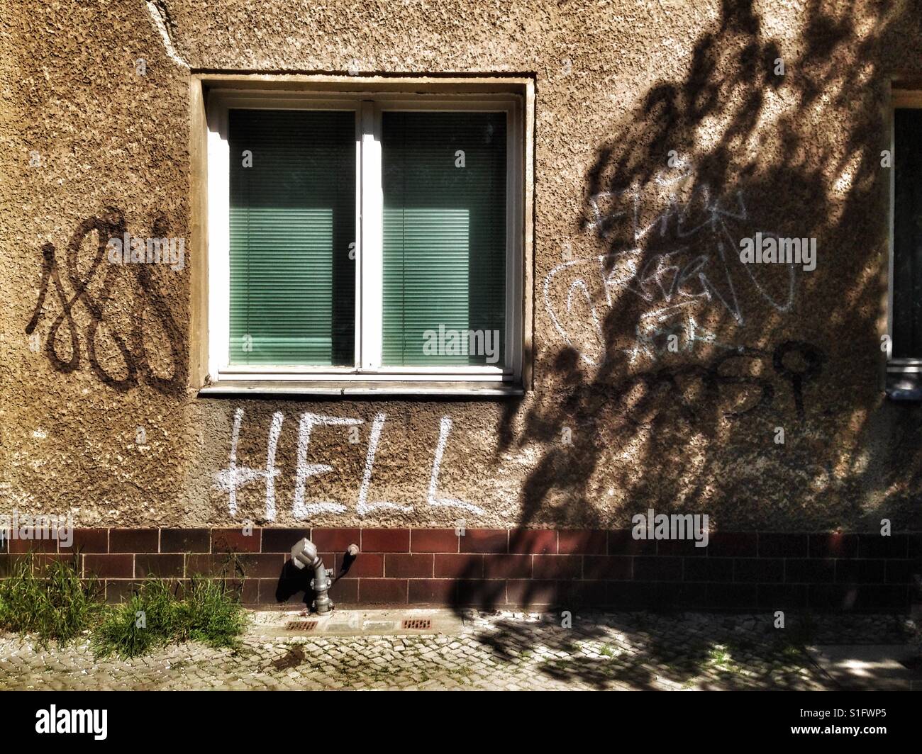 The word hell written on a wall in Germany, concept for urban living as ...