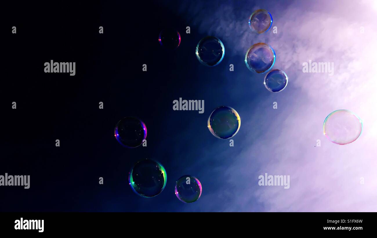 Soap bubbles floating up in the sky on a sunny day. Space for copy ...