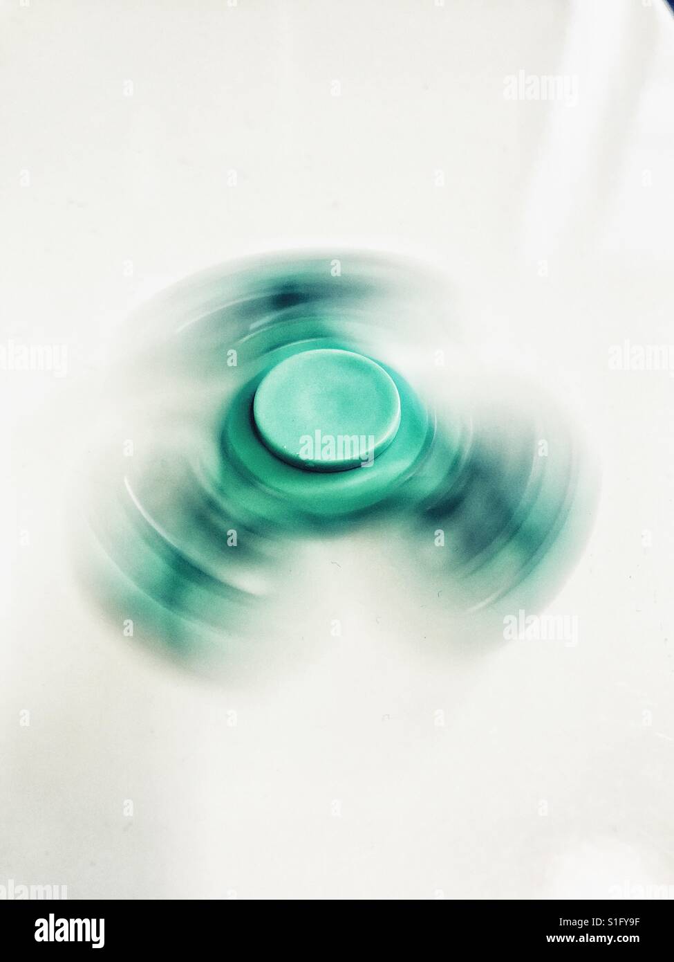 Green fidget spinner, spinning Stock Photo - Alamy