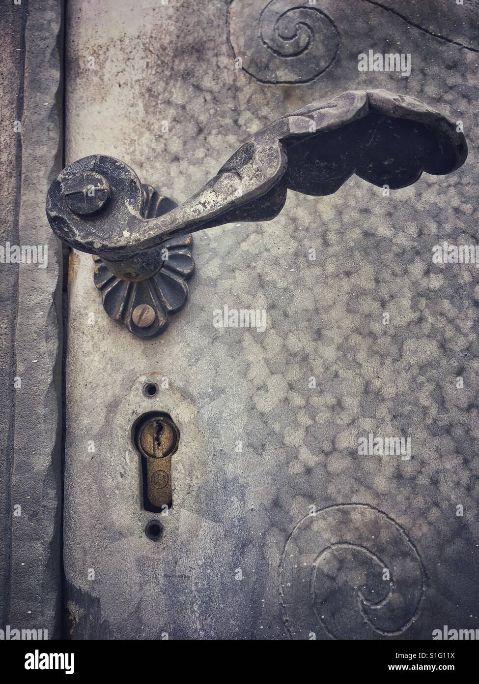 Old decorative vintage door lock and a handle Stock Photo - Alamy