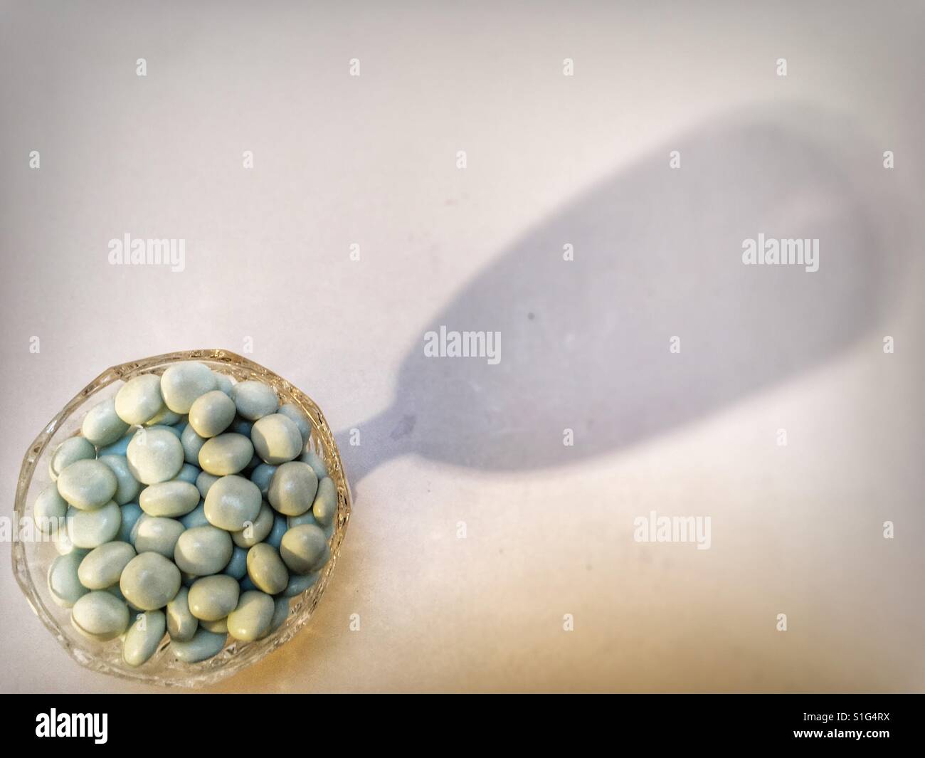 Glass sweet bowl full of chewy mints Stock Photo - Alamy