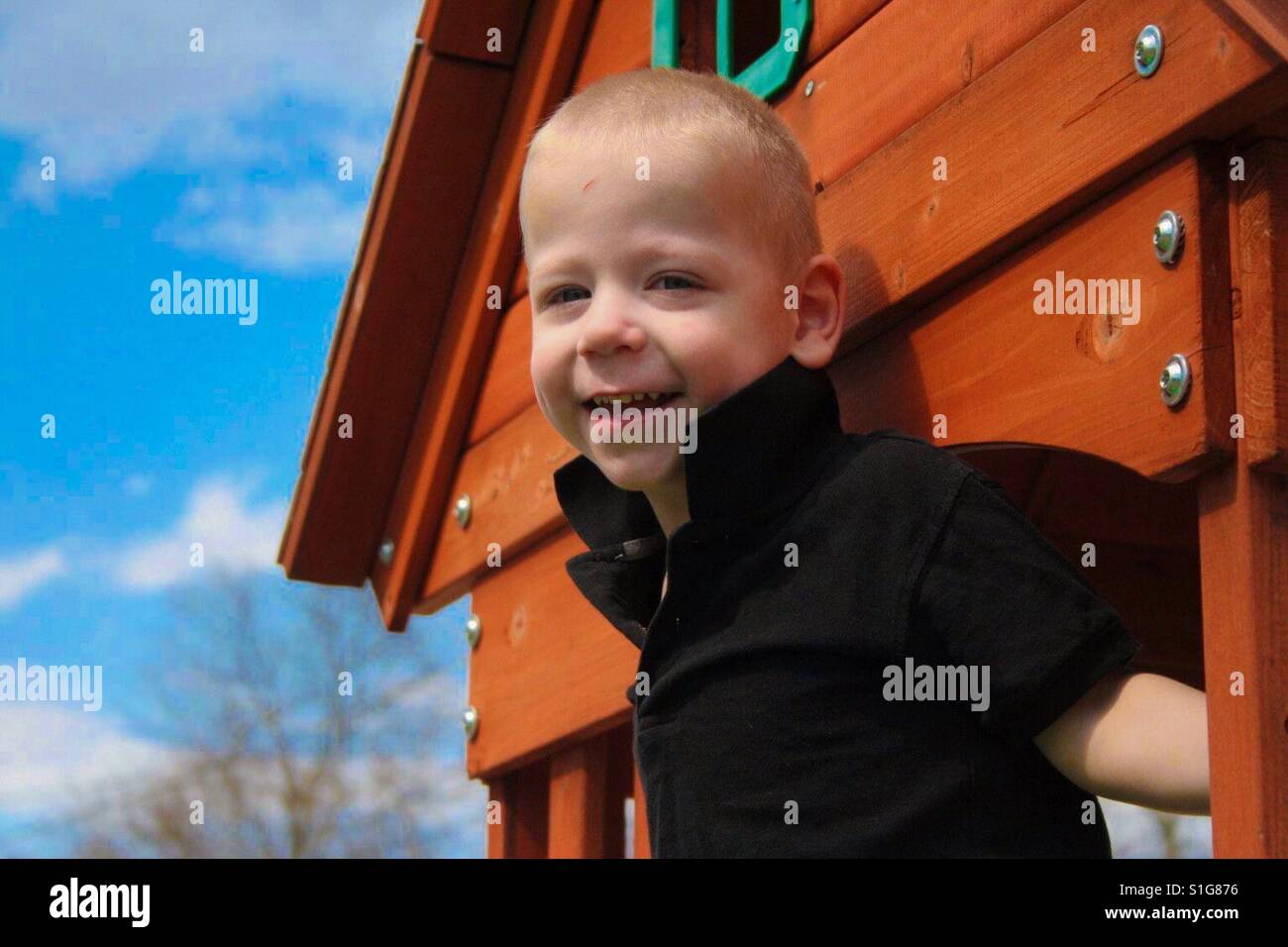 Baby playing on slide Stock Photo - Alamy
