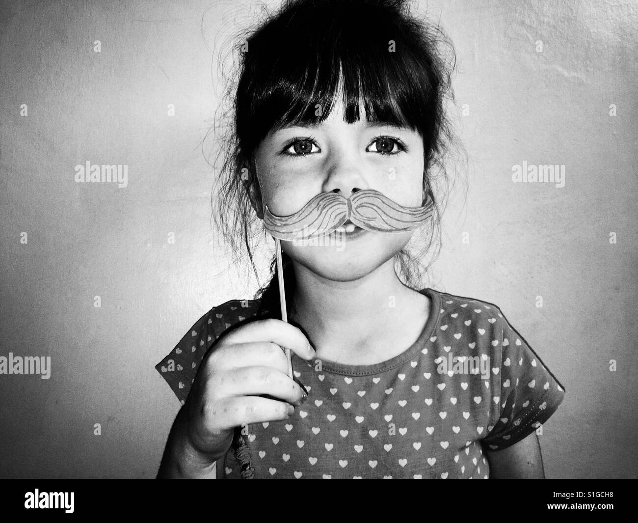 Girl with comedy moustache Stock Photo - Alamy