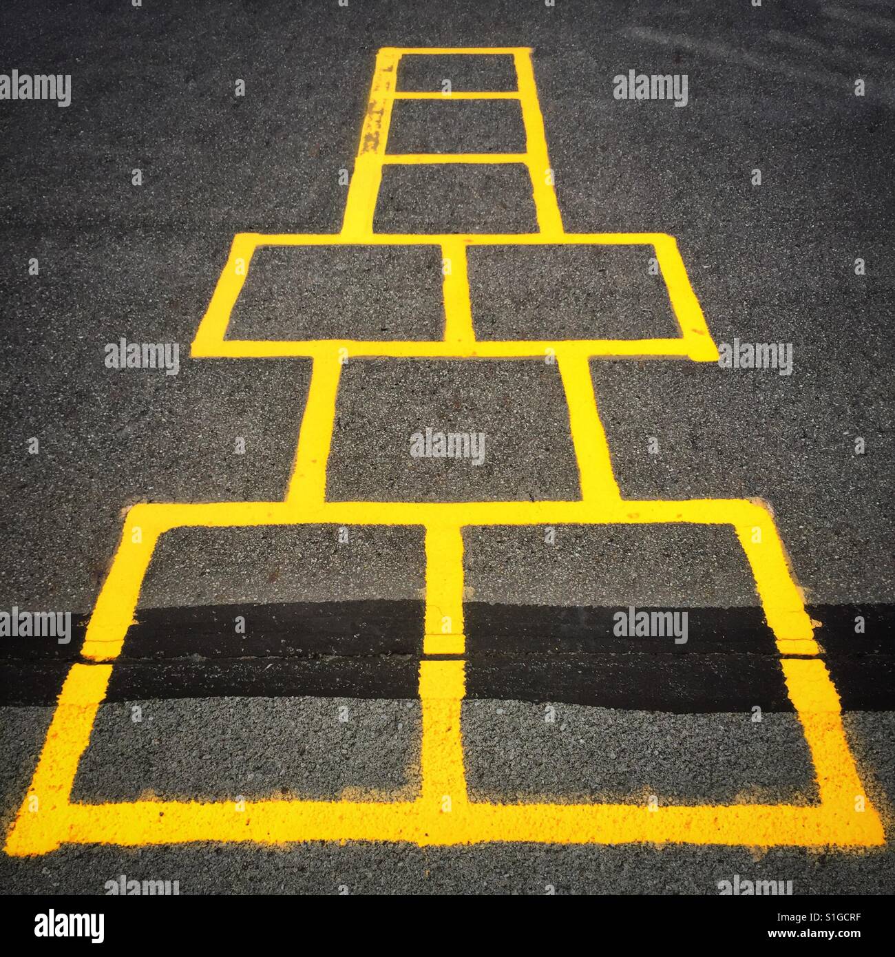 A series of yellow squares FB form a gameboard on the cement playground Stock Photo - Alamy