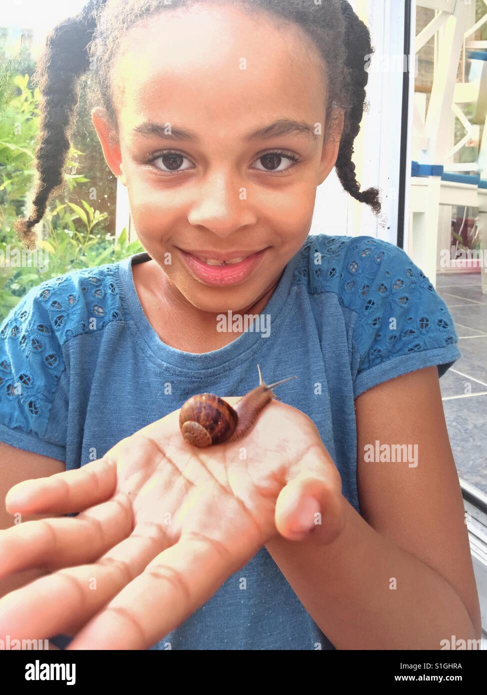 A young girl with a snail Stock Photo - Alamy