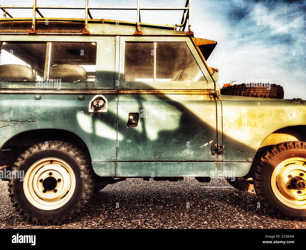 Vintage short wheel base Land Rover with the shadow of a Ford Transit ...