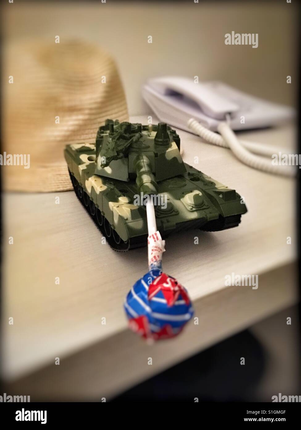 Toy tank with Lolly Pop in the gun barrel Stock Photo - Alamy