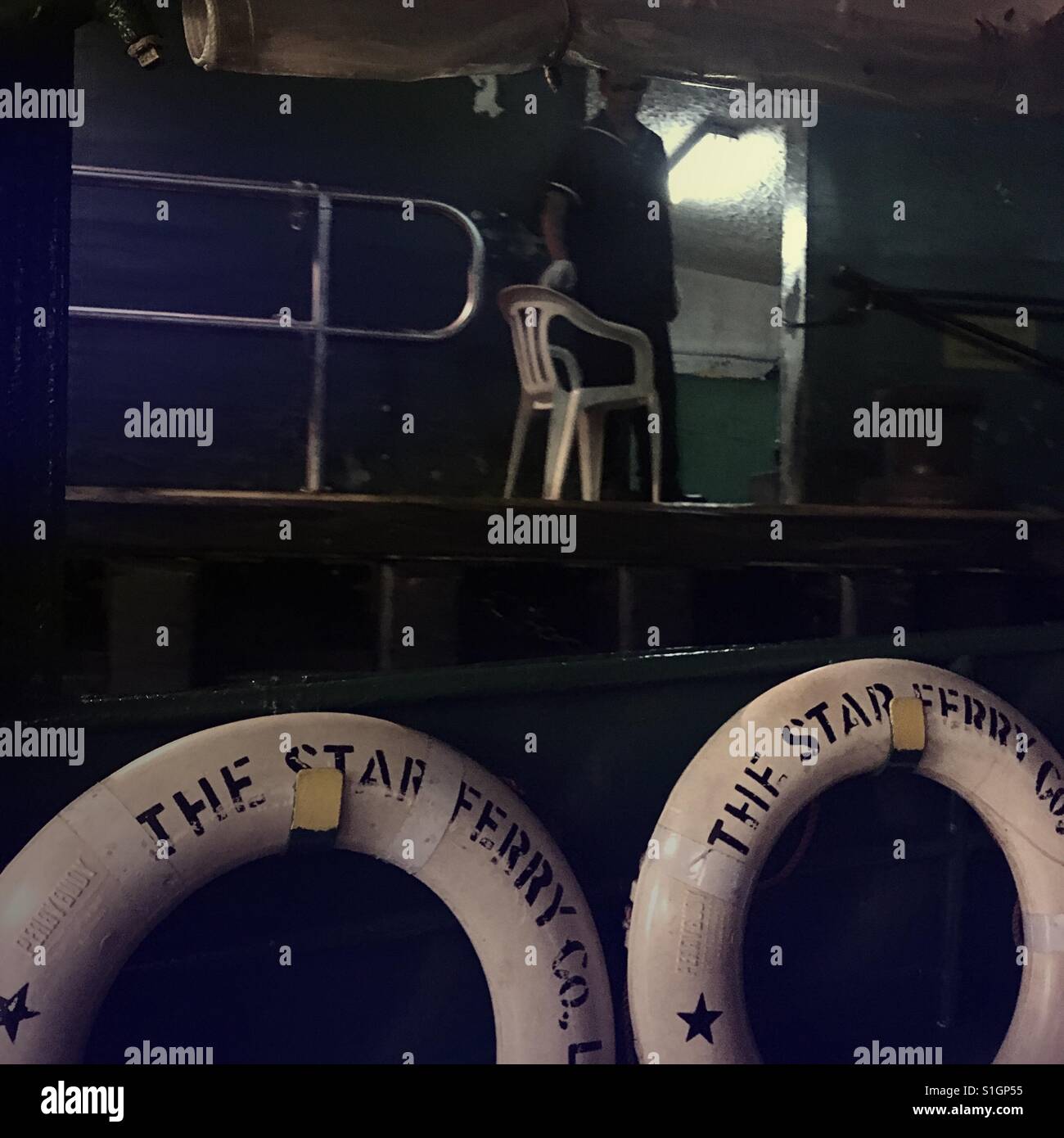 The Star Ferry worker is watching the approaching ferry Stock Photo - Alamy