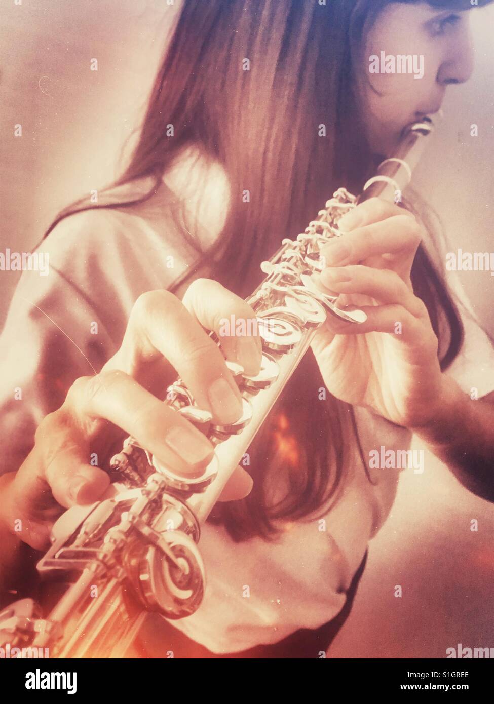 Young woman playing flute hi-res stock photography and images - Alamy