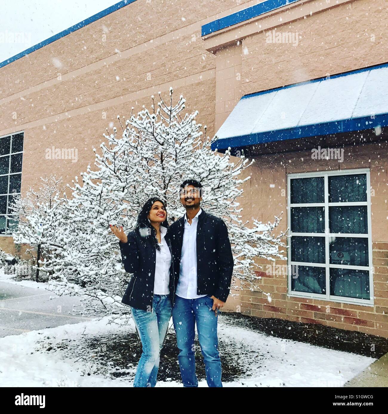 Couple enjoying snowfall hi-res stock photography and images - Alamy