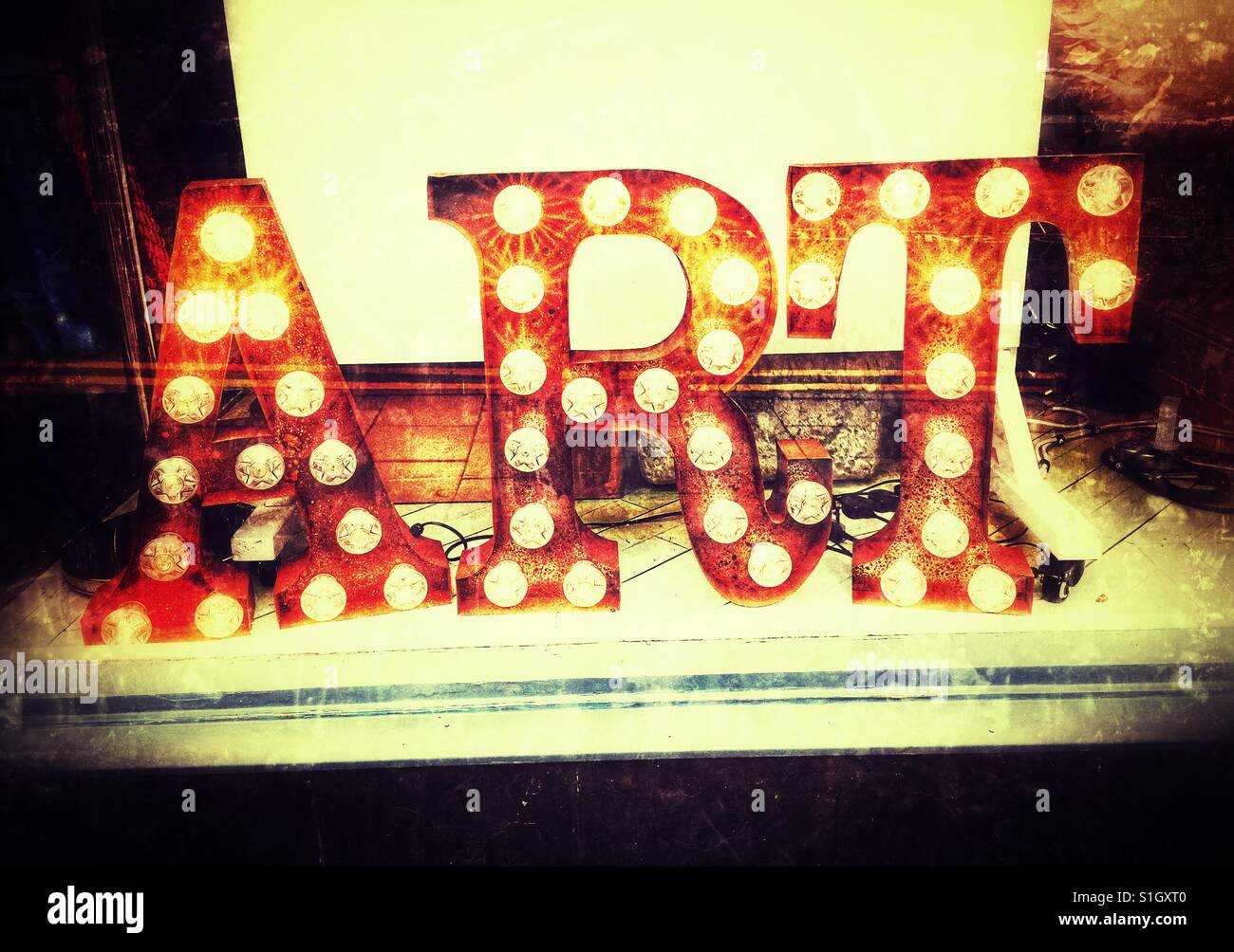 Illuminated art letters in window display Stock Photo - Alamy