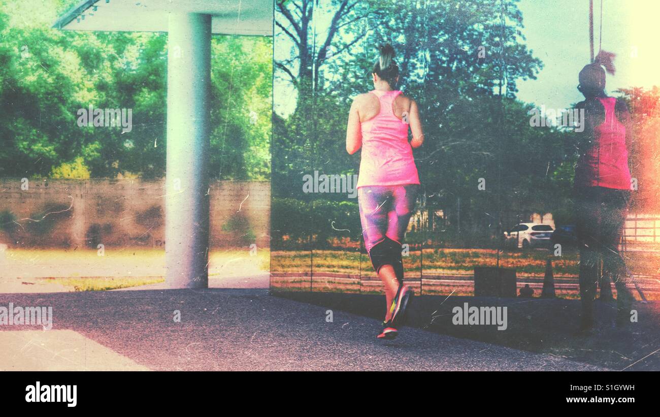 Woman running near a modern building Stock Photo - Alamy