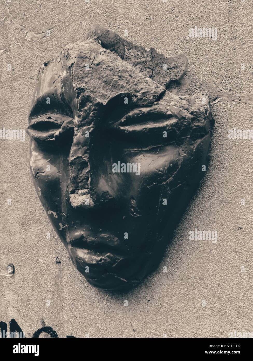 A damaged sculpture of a face on a wall in Bristol, UK Stock Photo - Alamy