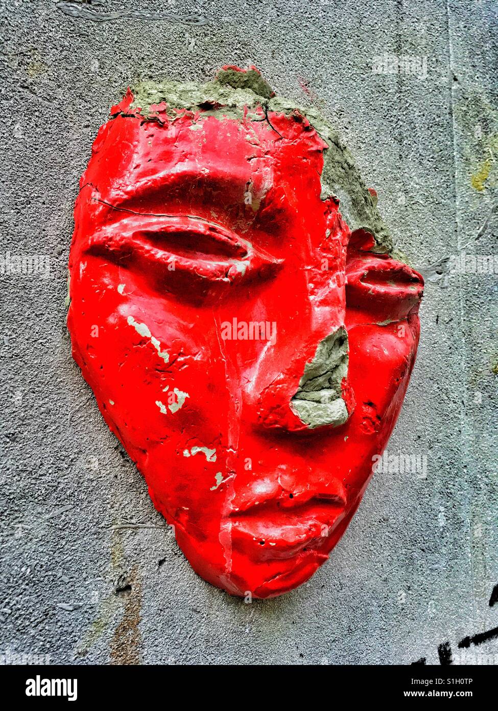 A damaged sculpture of a face on a wall in Bristol, UK Stock Photo - Alamy