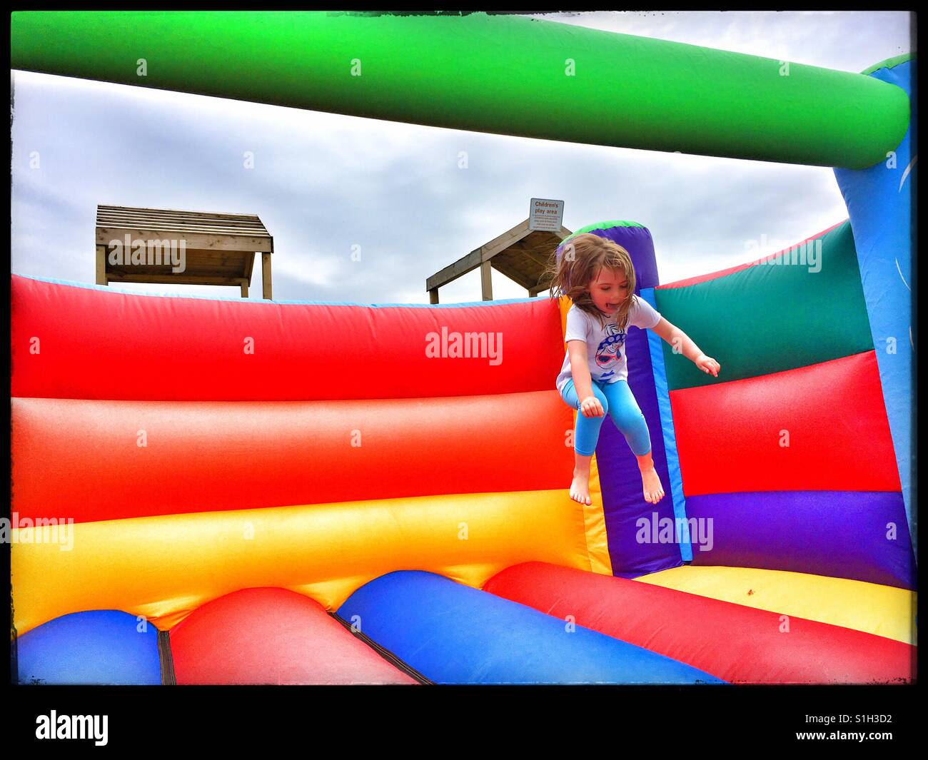 Girl on Bouncy Castle inflatable Stock Photo - Alamy