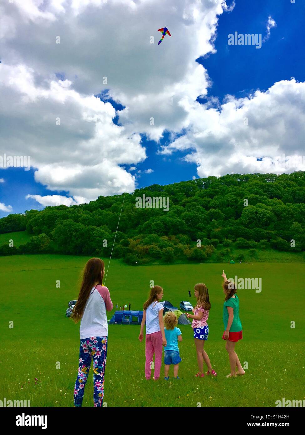 Kids flying a kite at a campsite Stock Photo - Alamy