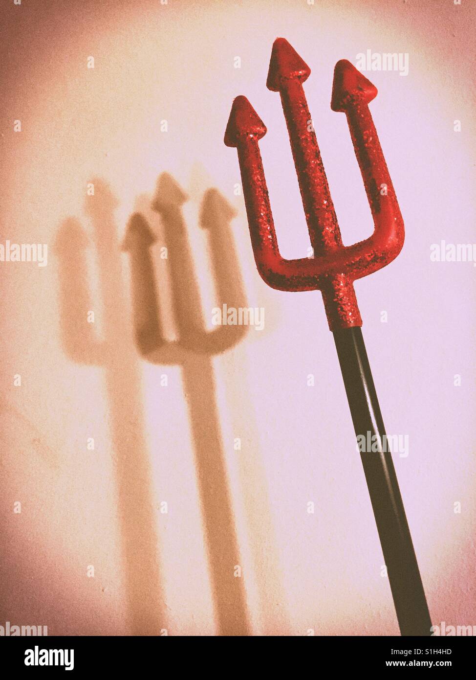 Devil fork with shadows Stock Photo - Alamy