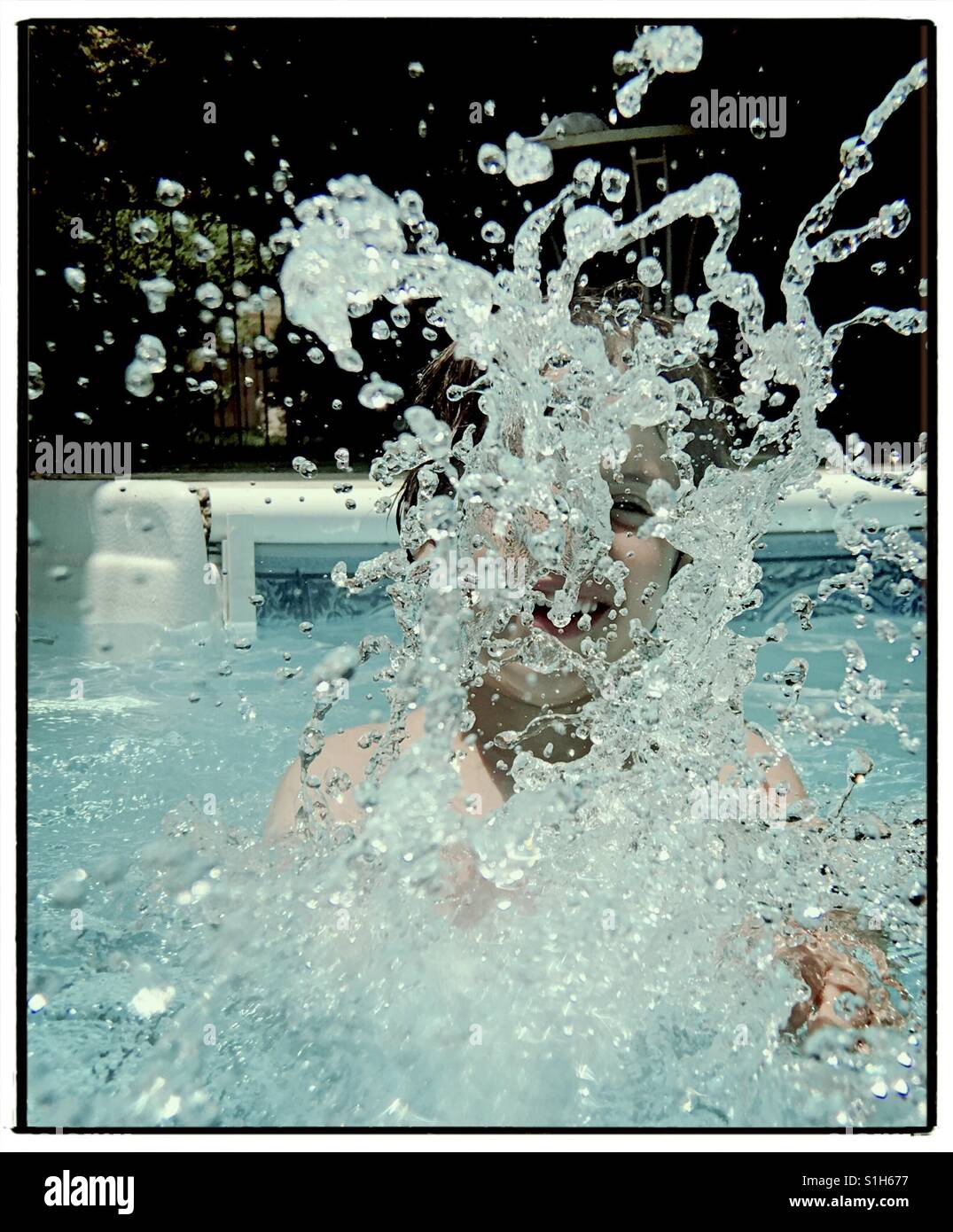 Boy splashing in water hi-res stock photography and images - Alamy