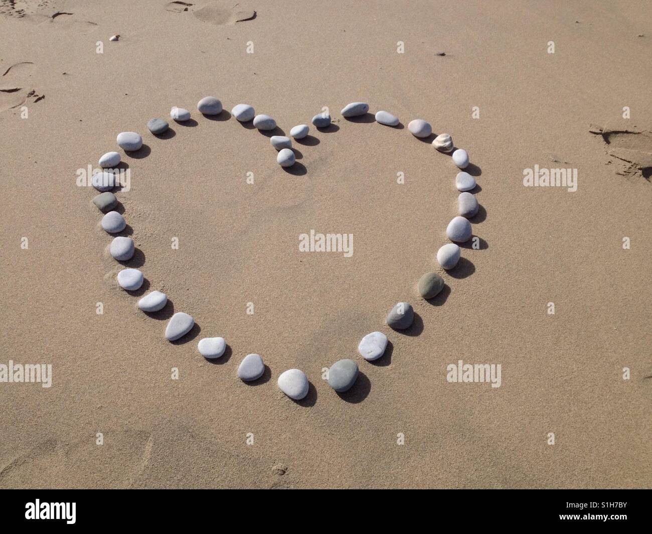 A heart of pebbles on a Welsh beach (landscape orientation). Rhyl ...