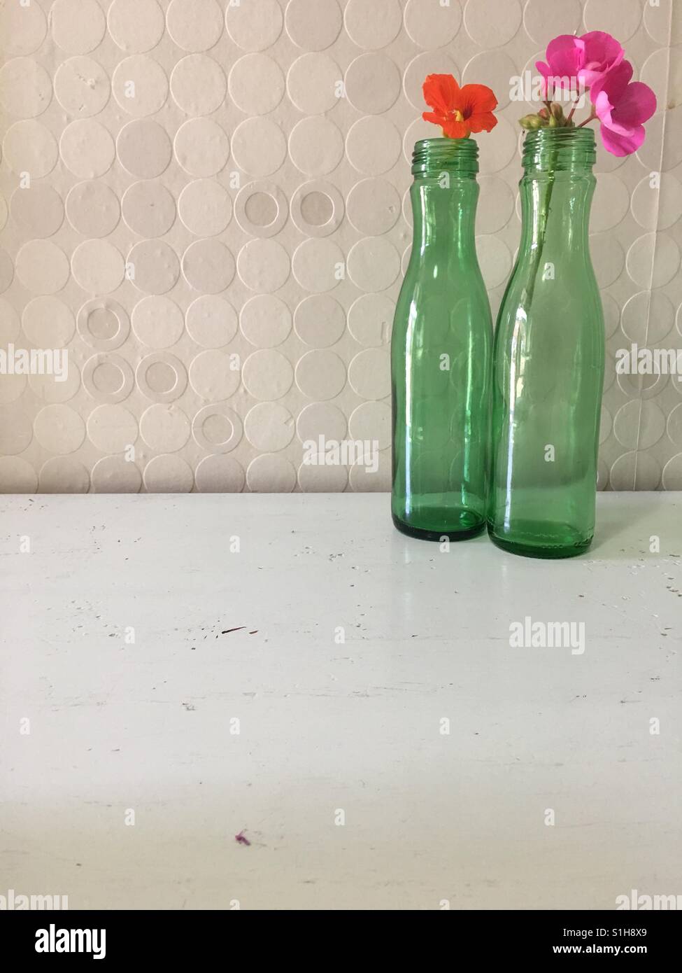 Two. Green bottles and two flowers against white background Stock Photo ... Two. Green bottles and two flowers against white background Stock Photo ...