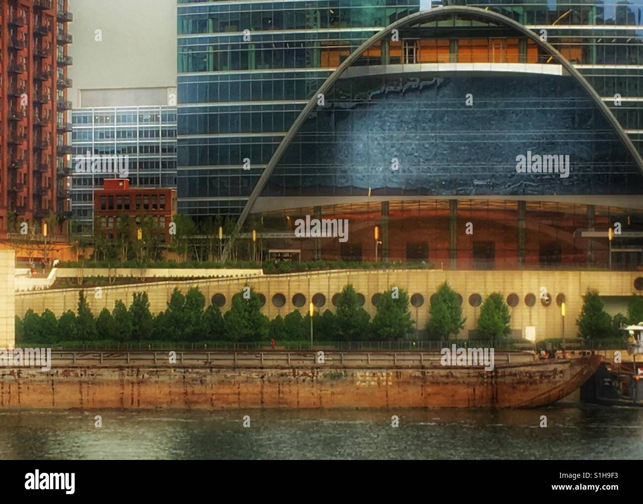 Barge passing along the Chicago River on a rainy day, and reflected in ...