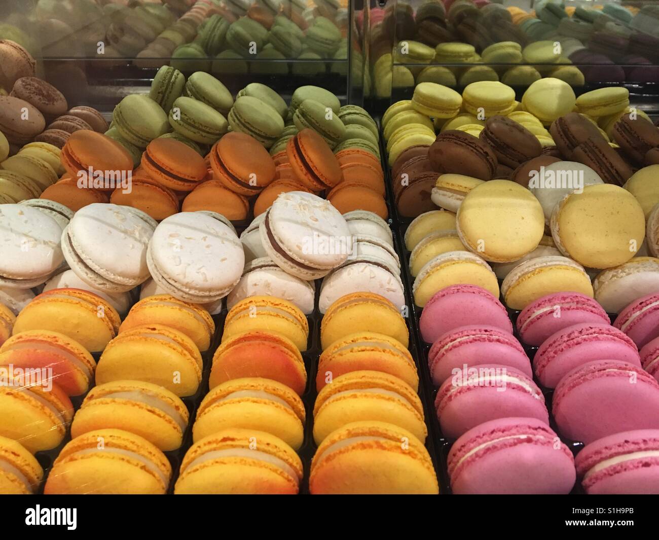 Rows of Macaroons on display in store Stock Photo - Alamy