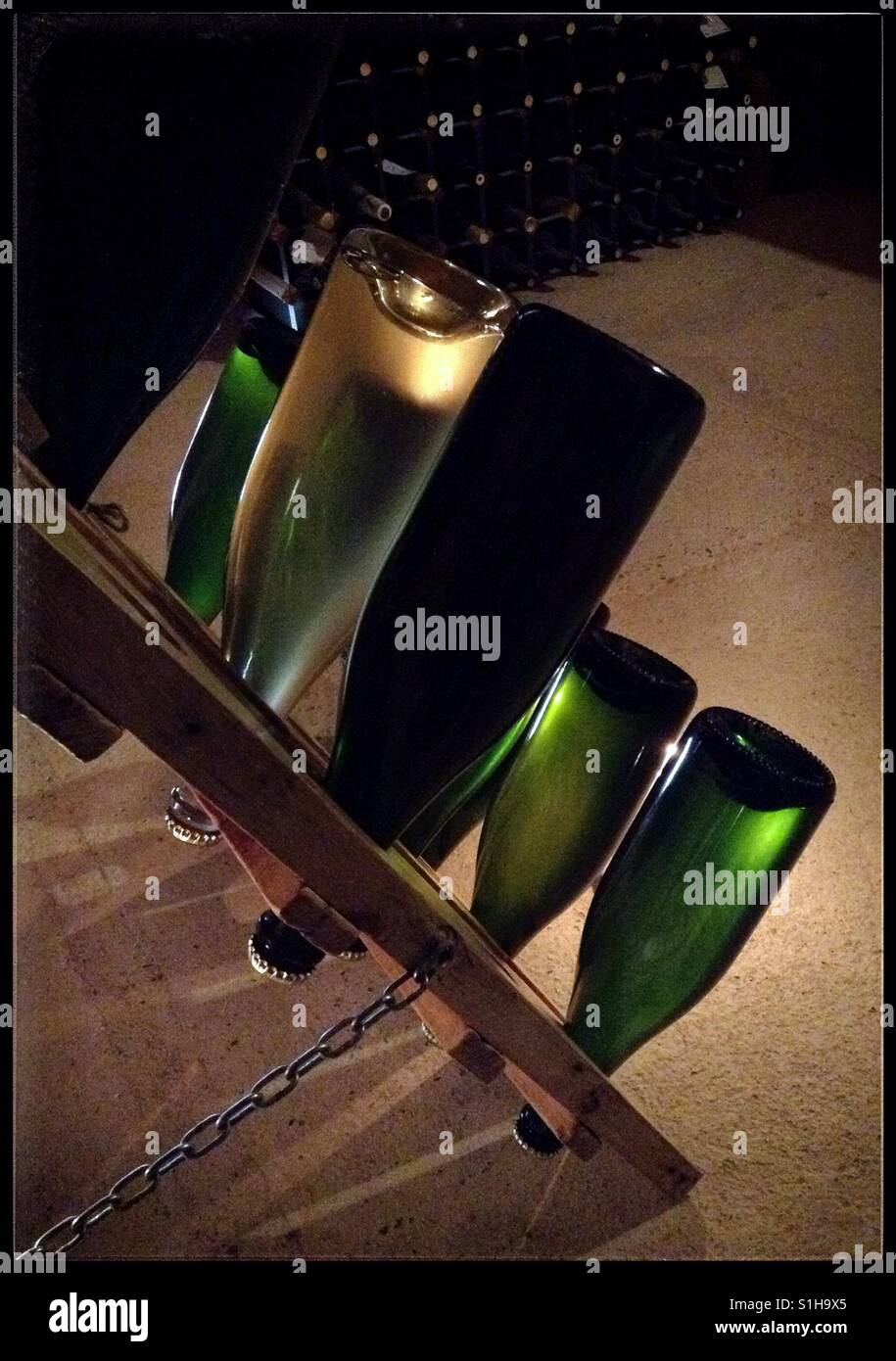 The process of riddling homemade sparkling wine using a traditional ...