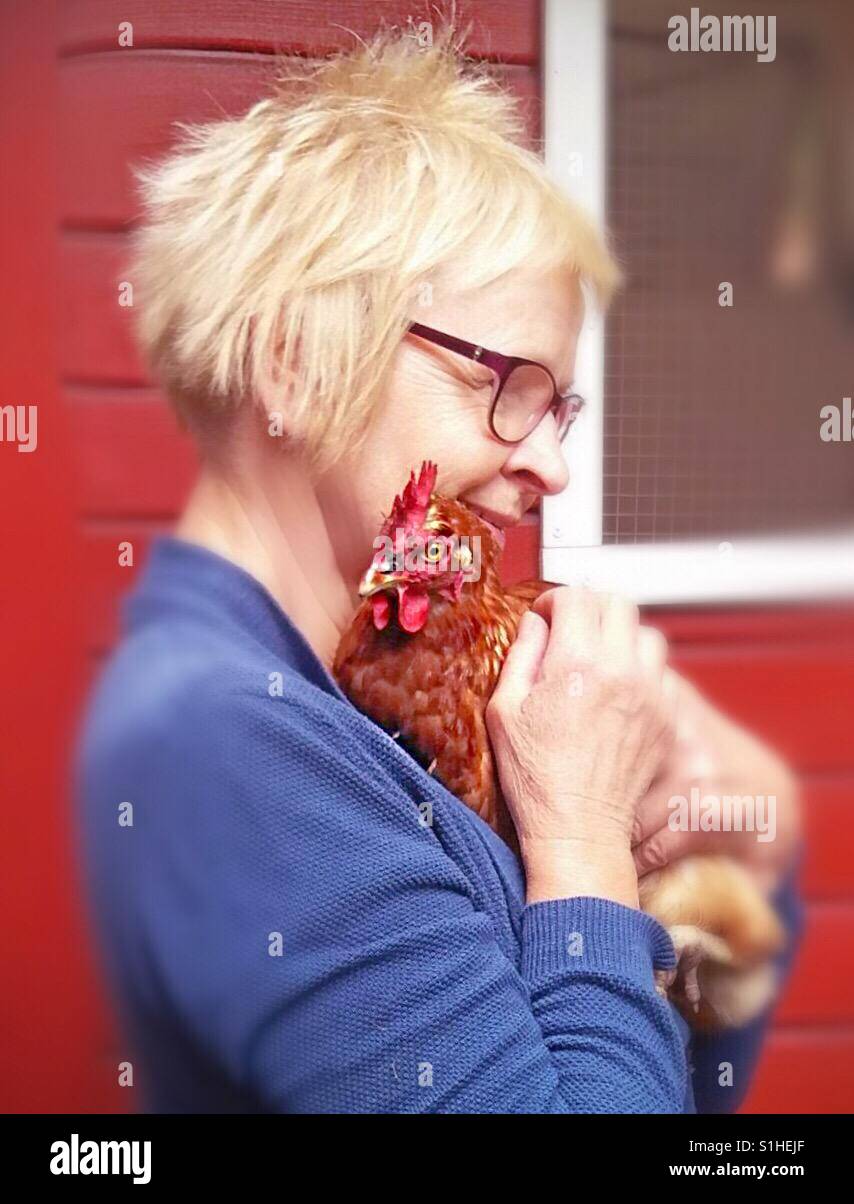 Fine woman with chicken Stock Photo - Alamy