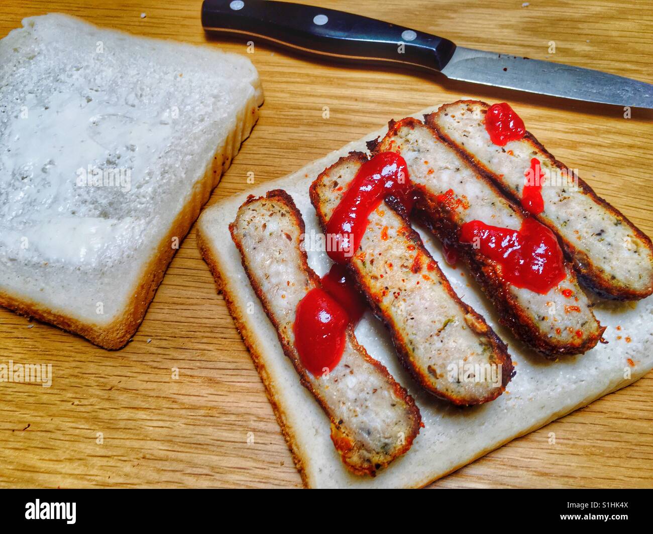 Sausage sandwich with tomato ketchup Stock Photo - Alamy