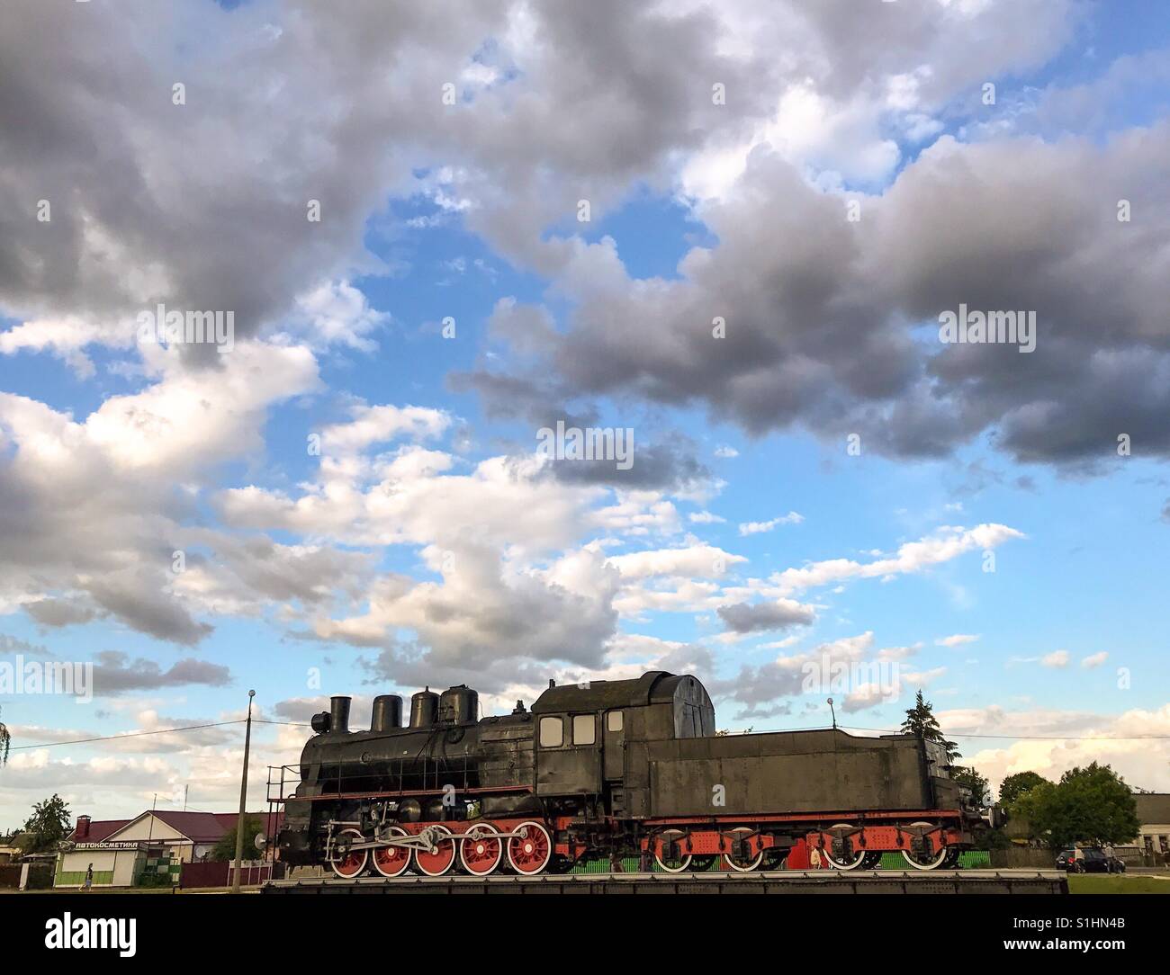 Old steam locomotive on a cloudy blue sky background Stock Photo - Alamy