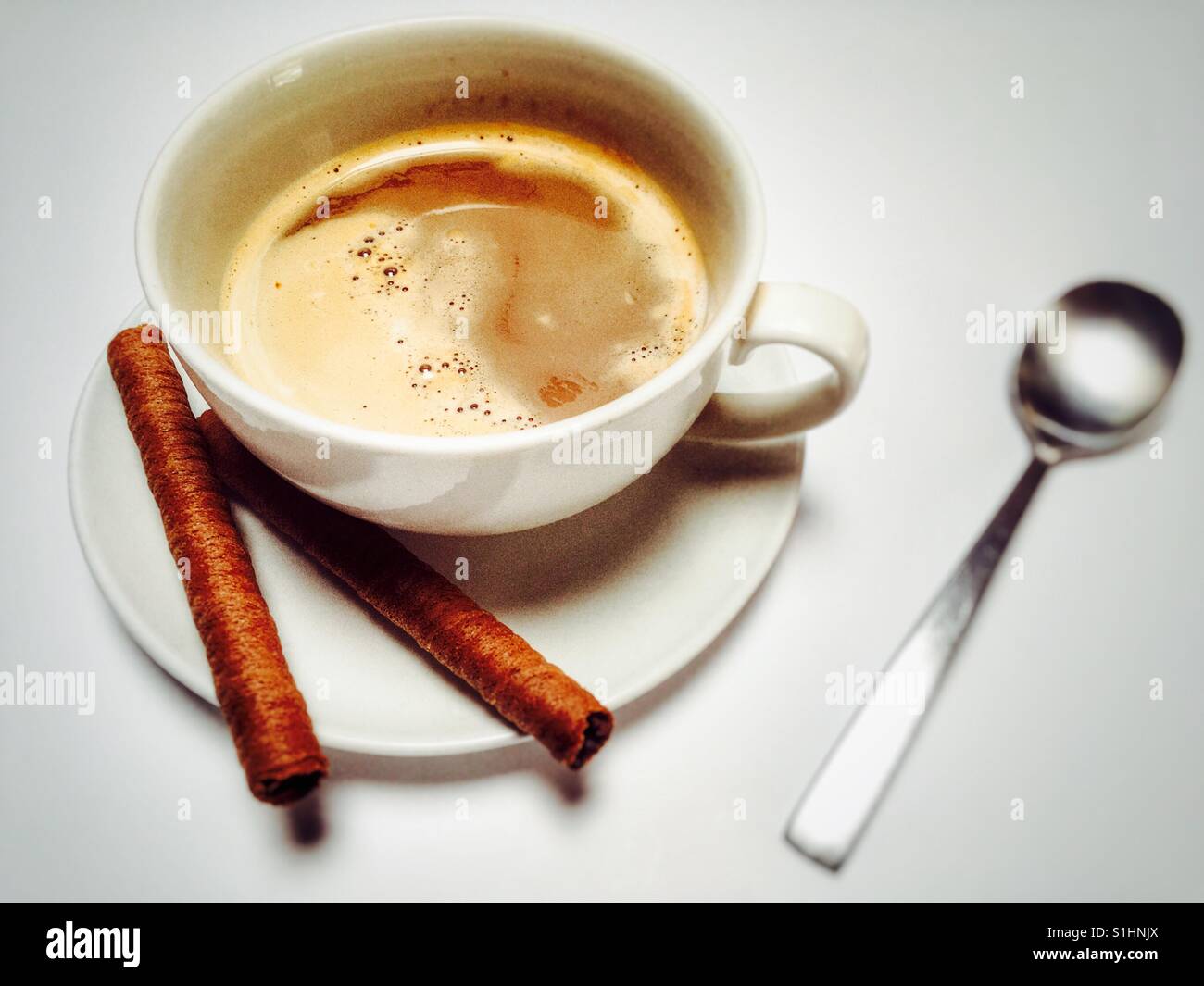 Coffee with wafer rolls Stock Photo - Alamy