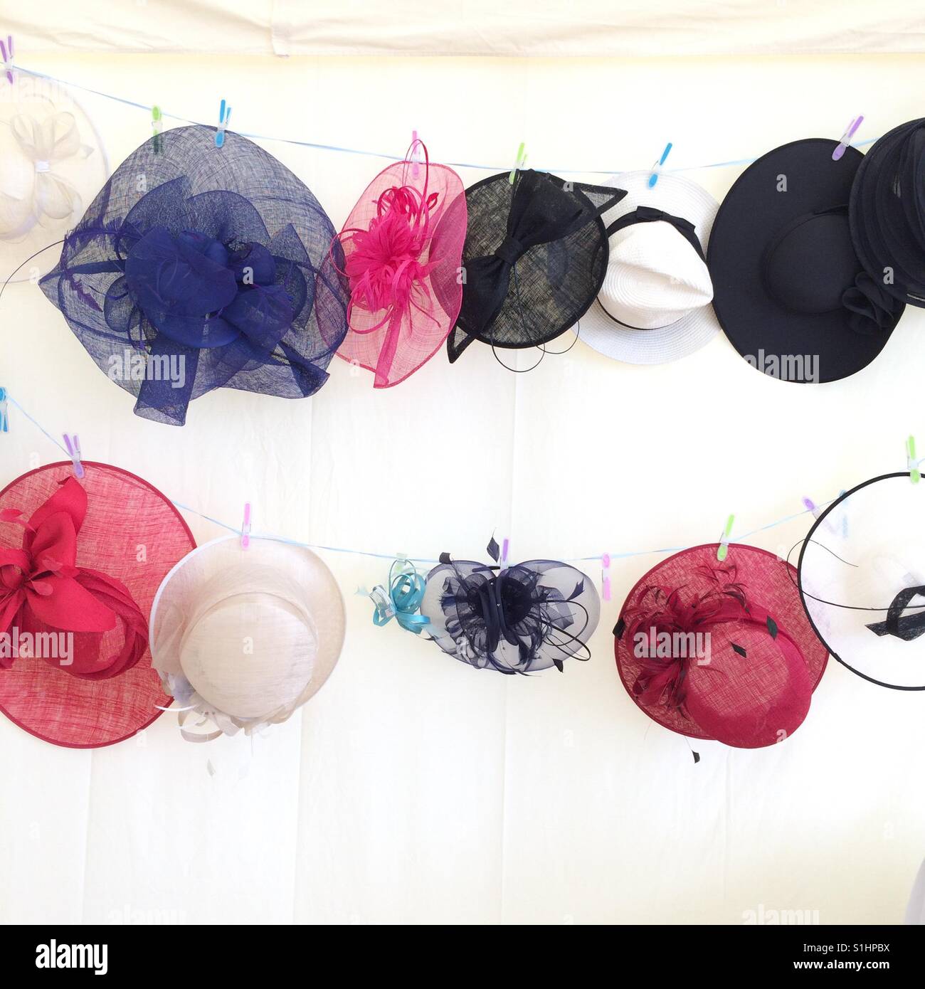 Colourful hats hanging on lines in a marquee at a wedding Stock Photo ...