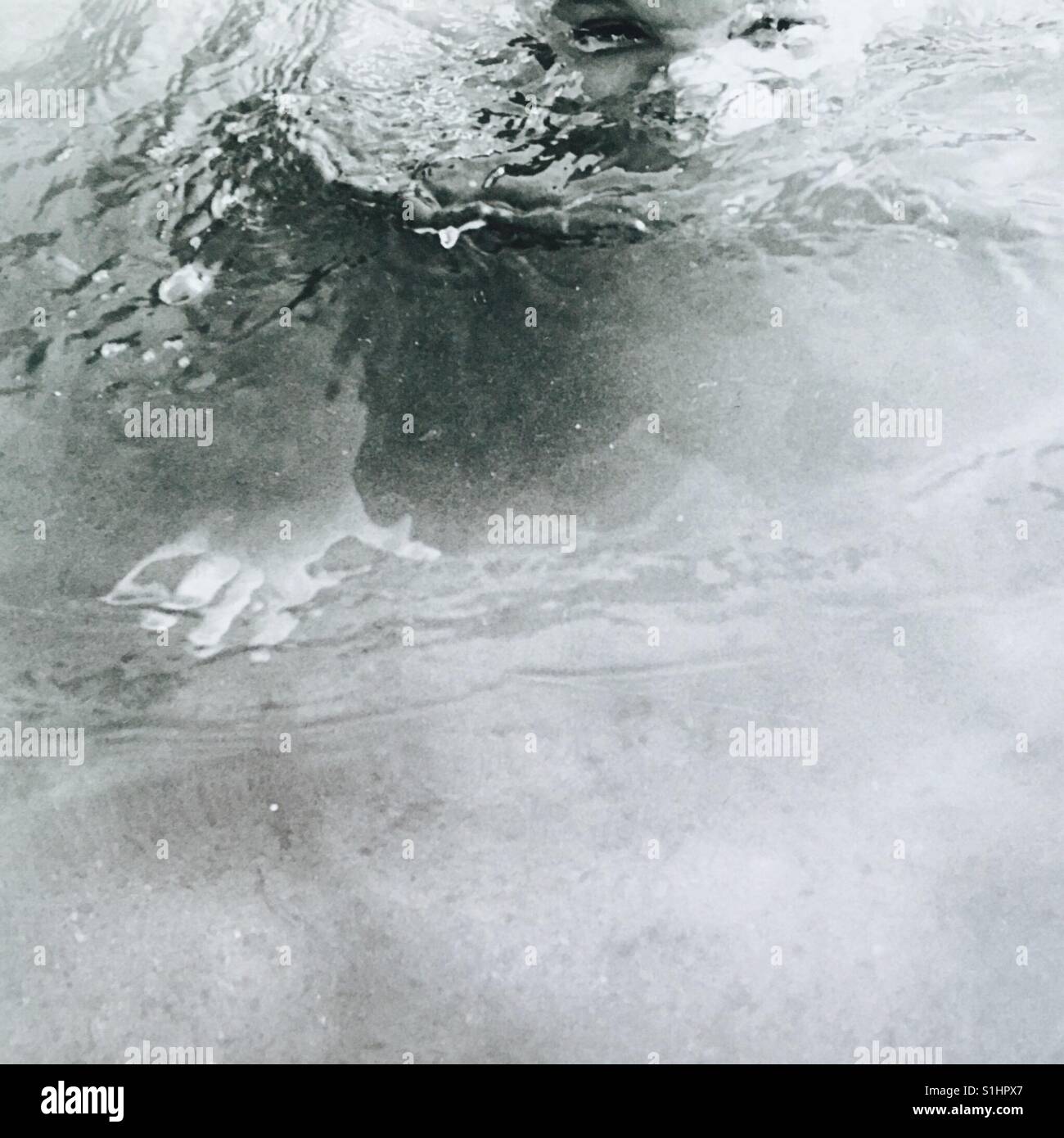 Boy submerged in swimming pool in B&W photo shows movement Stock Photo ...