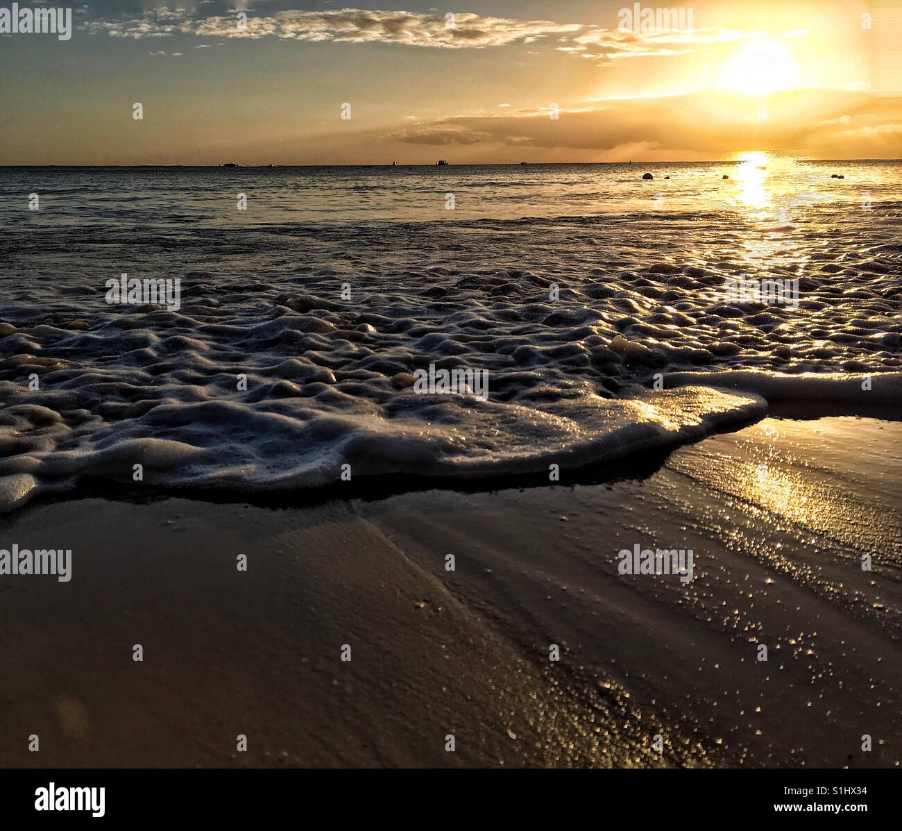 Sunset on the beach Stock Photo - Alamy