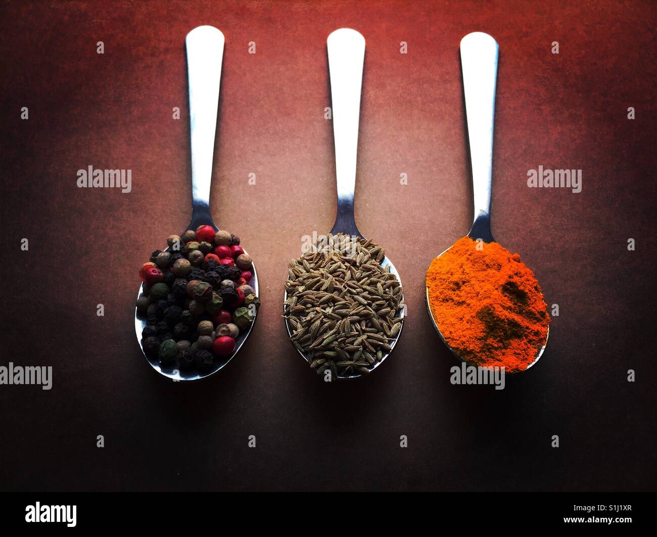 Three spoons containing three different spices Stock Photo - Alamy