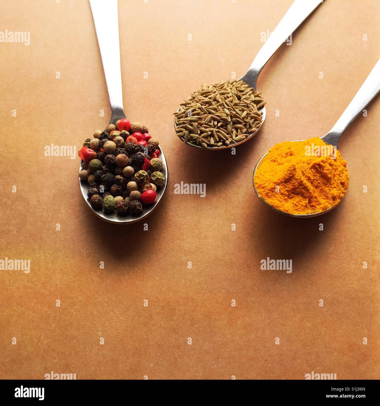 Three spoons containing three different spices Stock Photo - Alamy