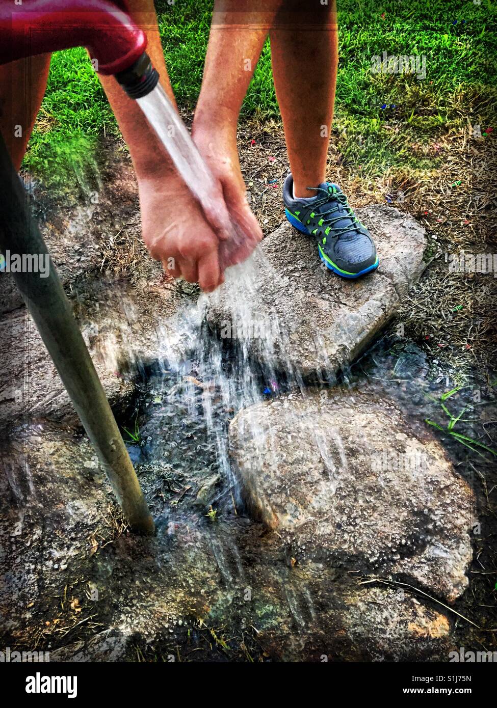 Boy washing his hands from a well Stock Photo - Alamy