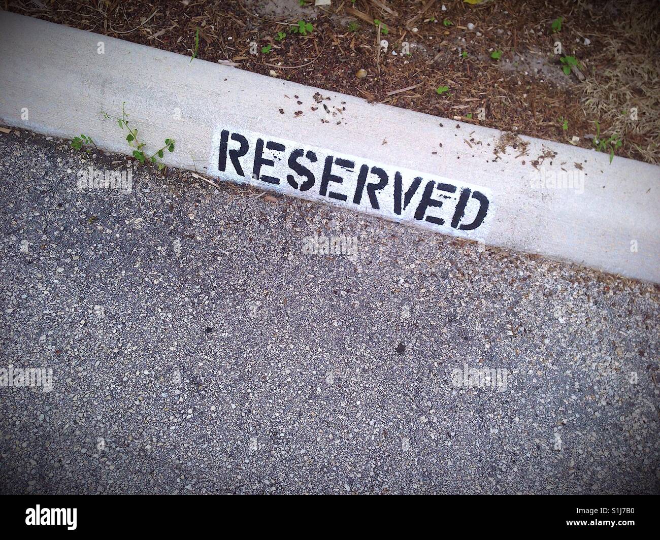 close up reserved sign on parking lot Stock Photo - Alamy